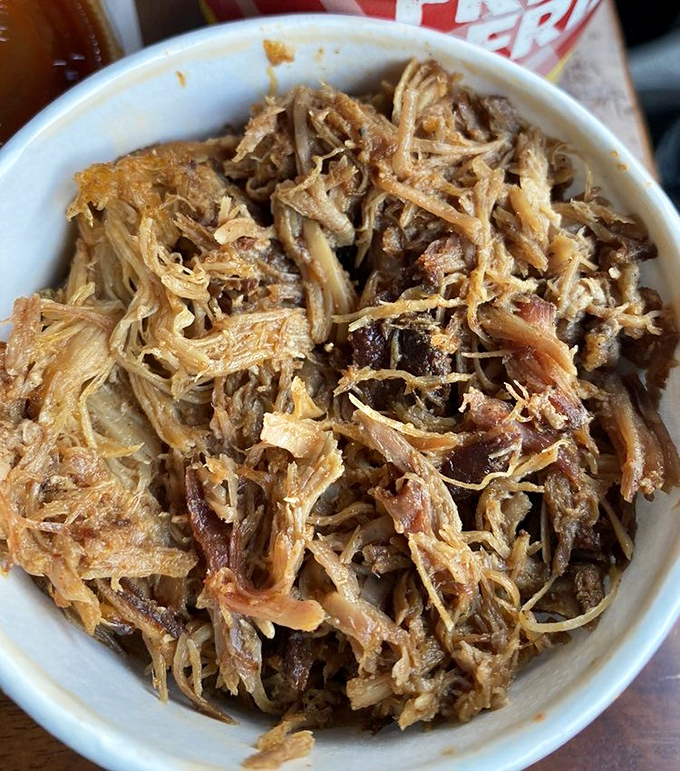 Pulled pork so perfectly shredded it looks like it was prepared by a team of meticulous squirrels with culinary degrees.