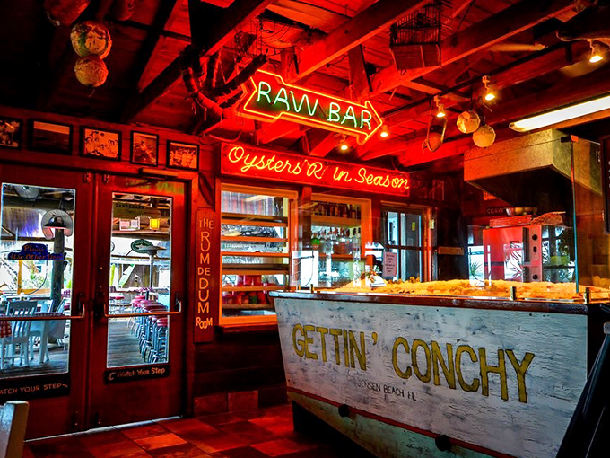 The "RAW BAR" sign glows like a beacon for seafood lovers. "Gettin' Conchy" isn't just a slogan, it's a lifestyle choice.