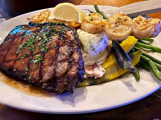 Surf and turf perfection! A masterfully grilled steak shares the spotlight with golden shrimp &ndash; the ultimate "why choose when you can have both?" plate.