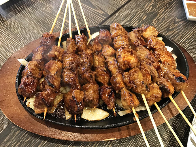 Satay skewers glistening with caramelization, arranged like a meaty sunburst. The perfect sharing plate that nobody actually wants to share.