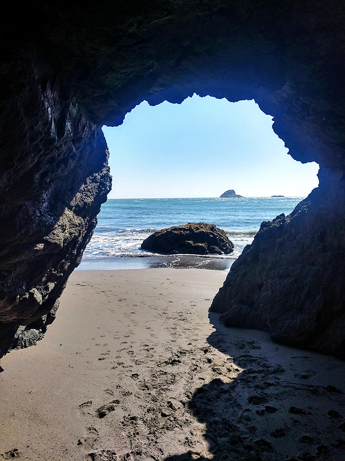 Nature's perfect frame – this sea cave opening reveals the Pacific's endless blue canvas, proving some art galleries have no walls.