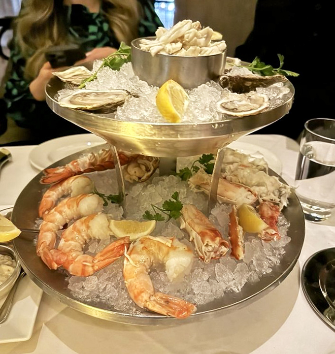 A seafood tower that demands respect and Instagram attention. Ocean treasures arranged like jewelry, but infinitely more delicious.