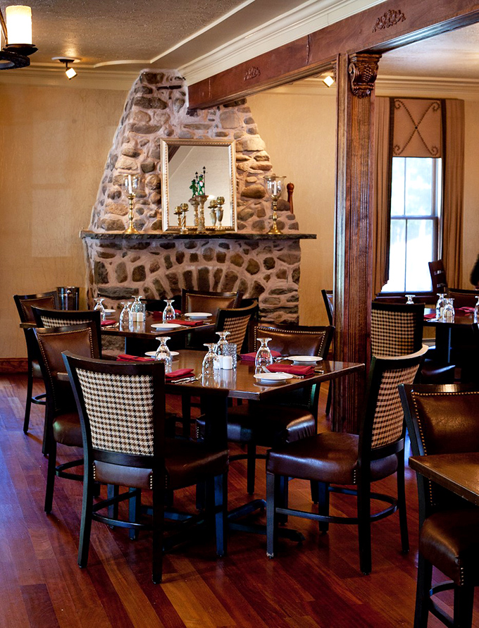 The stone fireplace creates a cozy backdrop for tables where "just one more bite" becomes the evening's most repeated phrase.