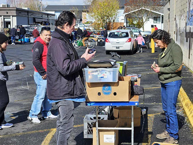 The delicate dance of negotiation unfolds over a plastic bin of curiosities. Calculator in hand, but instinct makes the deal.