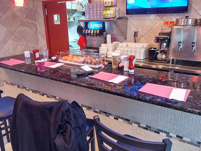 The counter – where solo diners find community and everyone's coffee cup mysteriously stays full without asking.