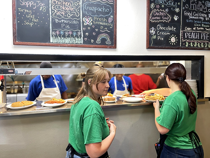 Behind the scenes where breakfast dreams become reality &ndash; the pass-through window frames a glimpse into the choreographed chaos of short-order cooking.