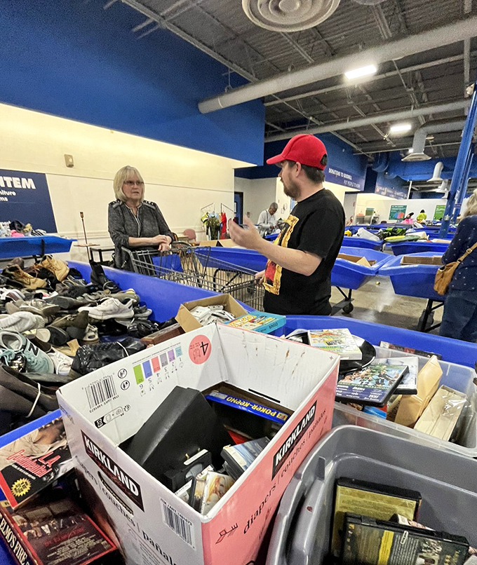 The thrill of the hunt in action. Shoppers navigate the blue bin landscape with the focus of archaeologists who've spotted something promising in the dig.