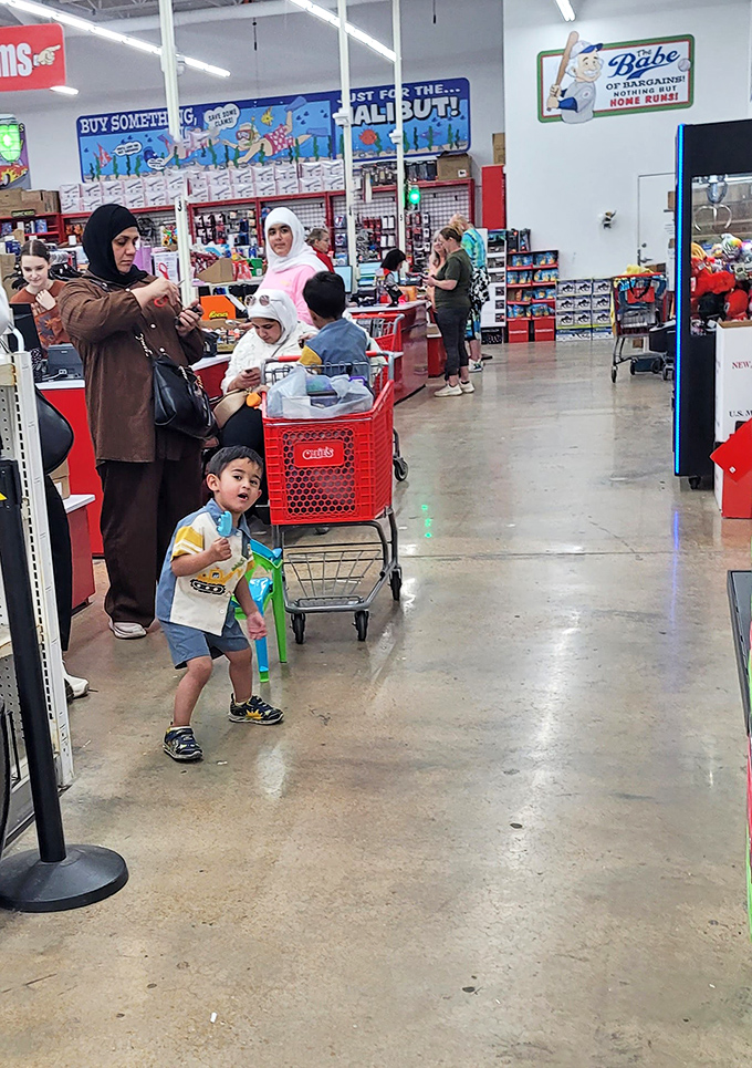 Happy hunters with their red carts full of treasures, proving that retail therapy doesn't require a therapist's salary.