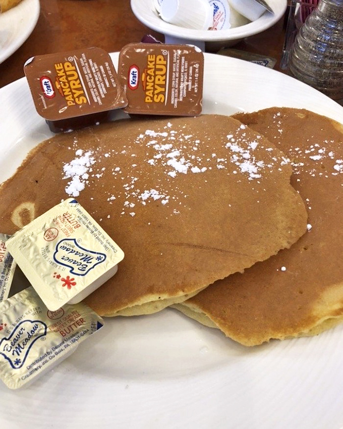 These pancakes aren't just breakfast&mdash;they're edible frisbees of joy, dusted with powdered sugar and waiting for their maple syrup baptism.