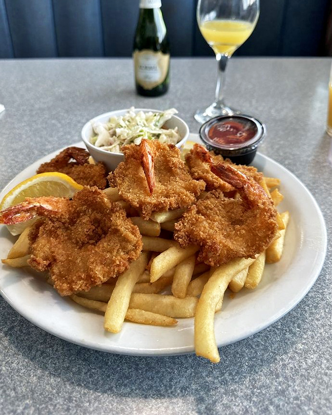 Crispy shrimp that snap like the punchline of a good joke, paired with fries that could make a Frenchman homesick.