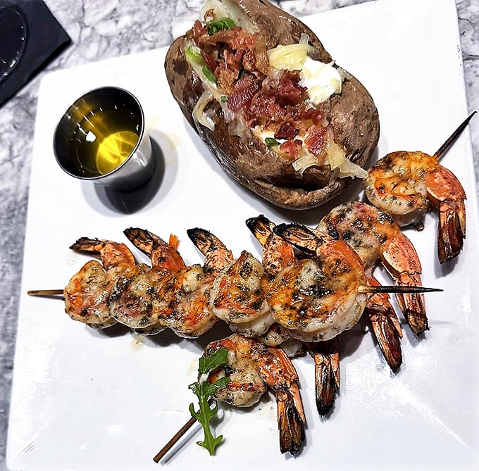 These grilled shrimp skewers with a loaded baked potato are what vacation decisions look like when made correctly.