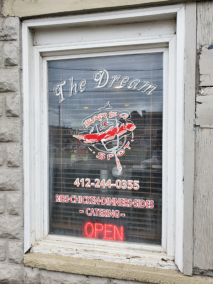 The window sign promises exactly what awaits inside: BBQ dreams that become delicious reality once you cross that threshold.