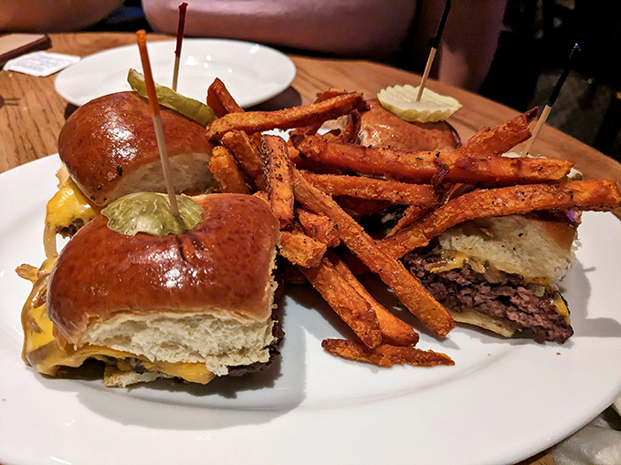 Sliders that prove good things come in small packages, flanked by sweet potato fries that deserve their own fan club.