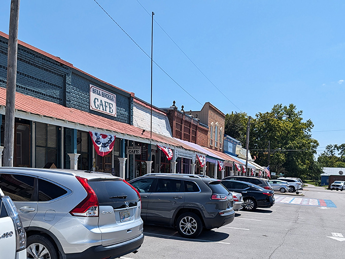 Summer's perfect blue sky frames the multicolored storefronts, where metal roofs have weathered decades of Tennessee seasons with grace.