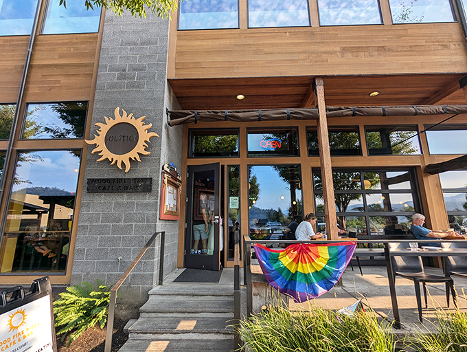 Solstice Wood Fire Pizza welcomes diners with modern architecture, rainbow flags, and the promise of perfectly blistered crusts inside.