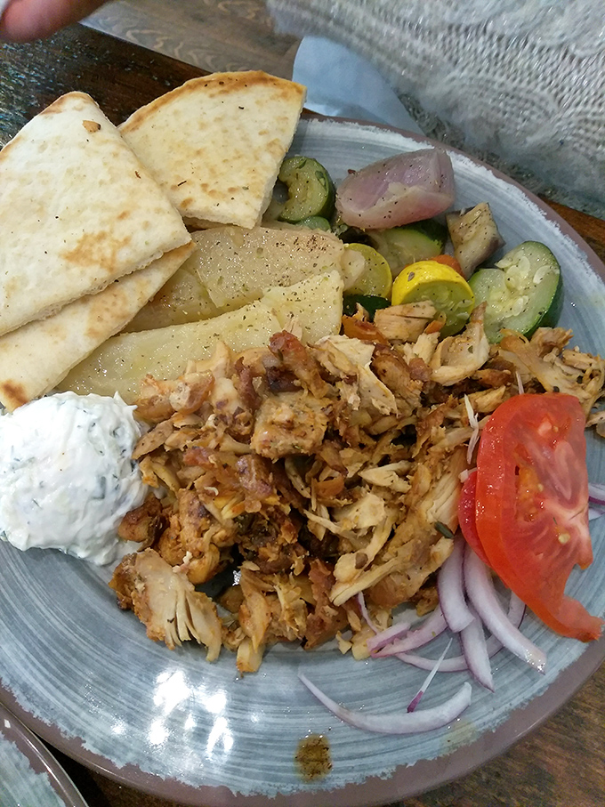 The souvlaki plate shows off the beauty of simple food done right. Tender chicken, roasted vegetables, and that tzatziki that dreams are made of.