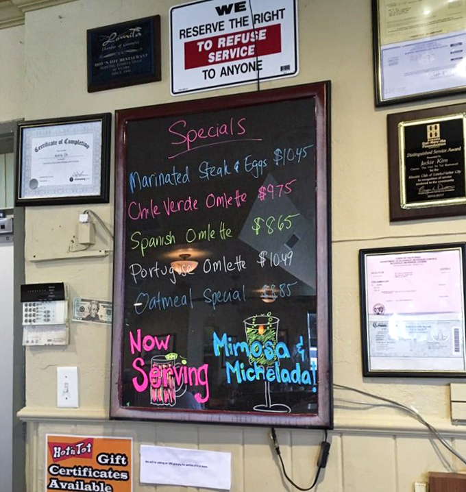 The specials board&mdash;a colorful canvas of culinary possibilities. Mimosas and micheladas suggest they understand weekend priorities.