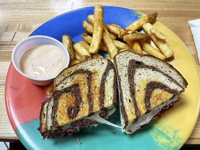 This Reuben sandwich with golden fries isn't just lunch—it's architecture, art, and comfort all stacked between perfectly grilled marble rye.