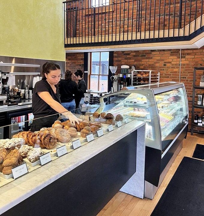The display case showcases an array of pastries so perfect they make you wonder if you're underdressed for this meeting with baked royalty.