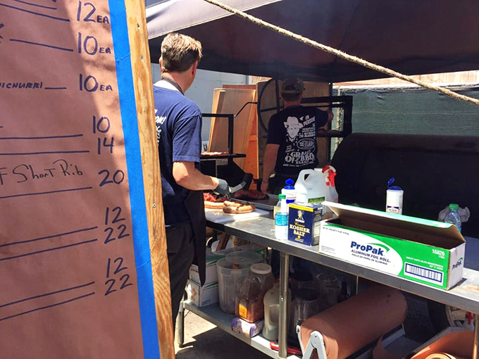 Behind the scenes where smoke and patience transform raw ingredients into art. That handwritten board tracks the day's treasures like a stock market of deliciousness.