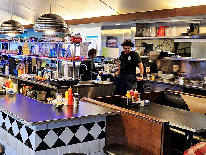 The open kitchen where breakfast magic happens – these aren't just cooks, they're morning miracle workers.