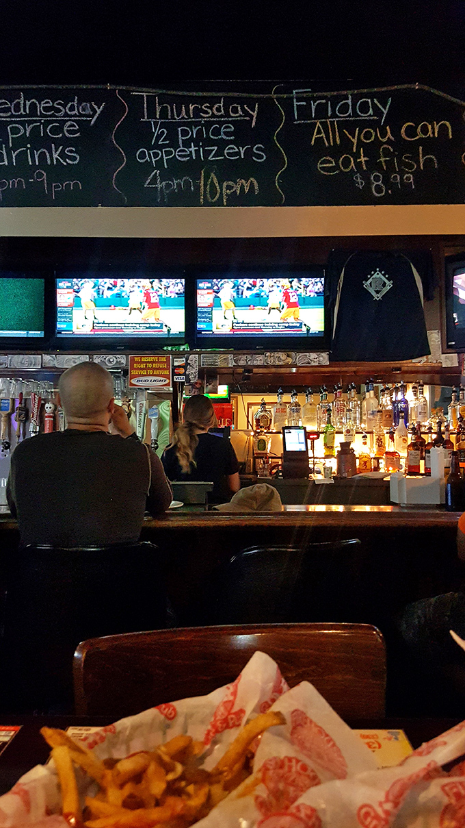 The bar area where sports are always on, drinks are always flowing, and the weekly specials are written in chalk like promises of good times ahead.