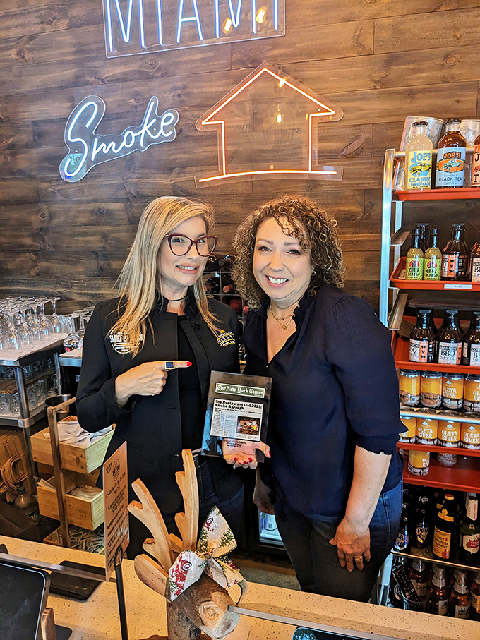 The passionate people behind the smoke and dough. Their smiles suggest they know something delicious that you're about to discover.