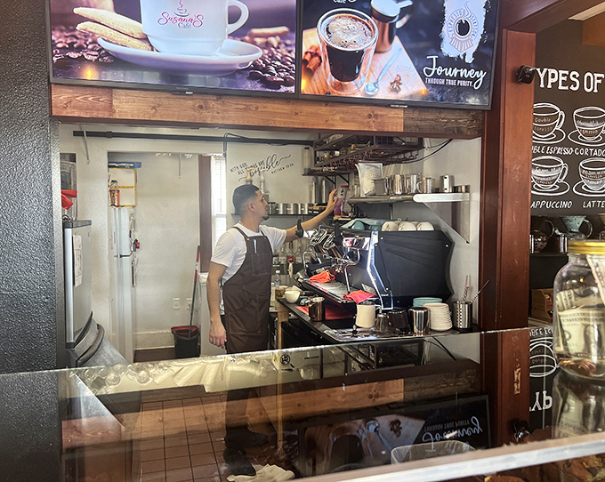Behind the scenes magic: the barista orchestrates each coffee creation with practiced precision, transforming simple beans into morning masterpieces.
