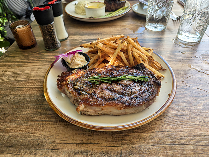 This isn't just a steak&mdash;it's a commitment to excellence, complete with a sprig of rosemary standing guard. Those fries look hand-cut and twice-fried, as God intended.