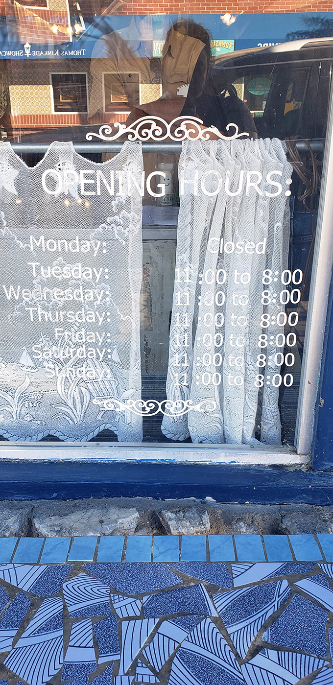 Hours posted on lace curtains&mdash;a charming touch that says "we're casual, but we take our seafood seriously."