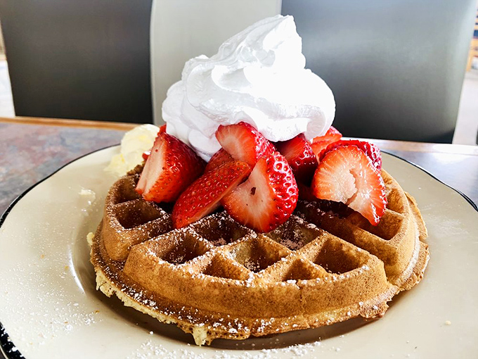 This waffle doesn't just carry strawberries&mdash;it showcases them like precious jewels, crowned with a dollop of whipped cream that's melting just so.
