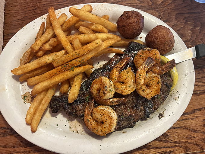 Surf and turf with a side of perfectly seasoned fries and hushpuppies—proof that sometimes more is exactly the right amount.