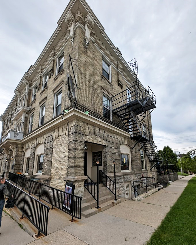 The Port Hotel's cream city brick façade hints at the historic elegance within. That fire escape might not be the main selling point, but it adds a dash of urban character to this small-town landmark.
