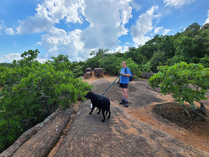A visitor and four-legged friend explore the trail, proving that geological wonders are best appreciated with good company, whether human or canine.