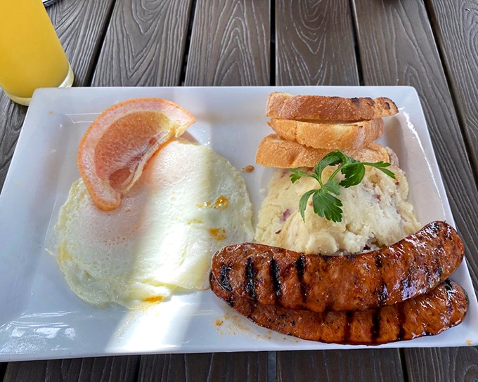 The breakfast trinity: perfect eggs, savory sausage, and potato magic. Simple food executed with the reverence it deserves.