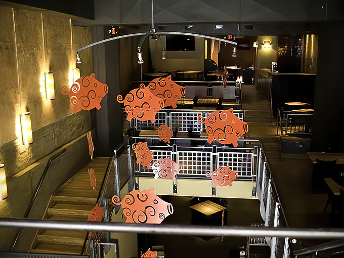 Whimsical pig cutouts dance above diners below. A playful reminder of the noble animal that makes much of this deliciousness possible.