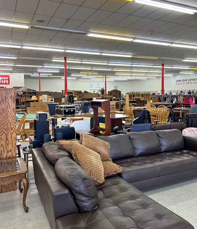 This leather sectional commands attention like a living room throne, complete with matching ottoman for proper lounging protocol.