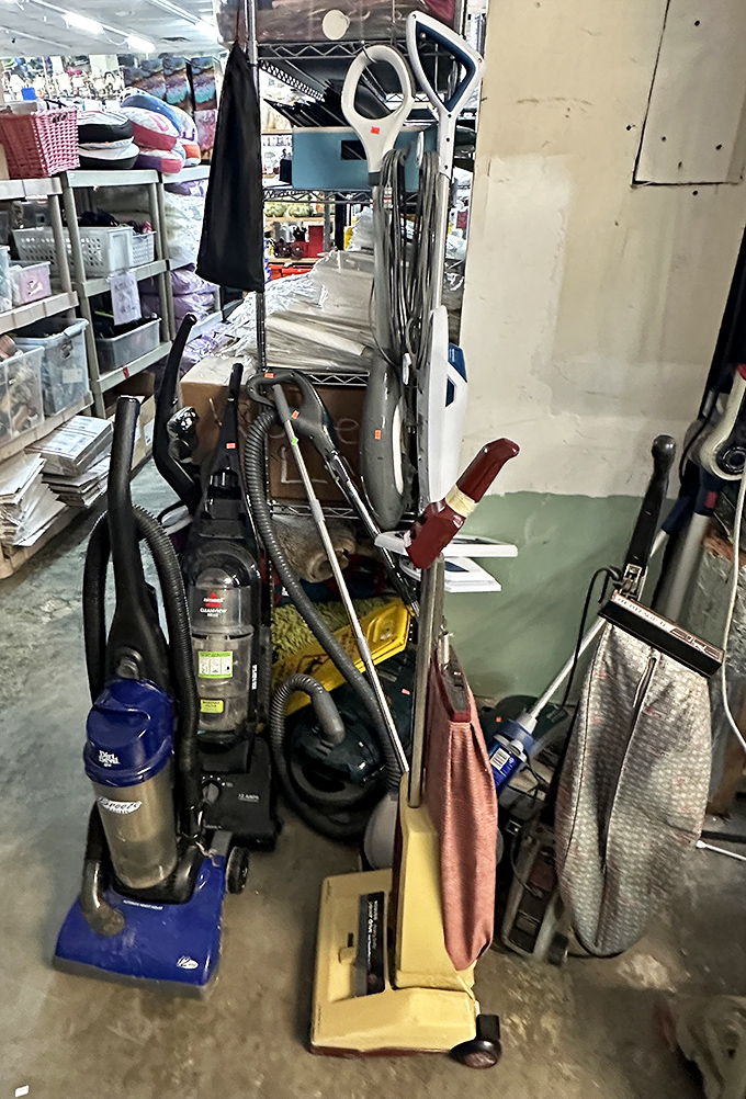 Vacuum cleaners standing at attention like soldiers ready to battle your dust bunnies. That blue Dirt Devil has seen things your floors can only imagine.