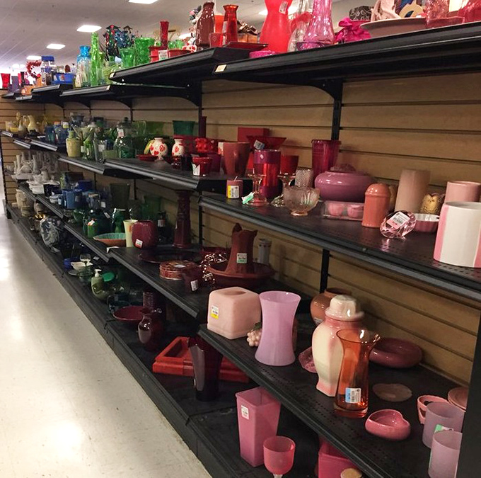 A rainbow of vintage glassware organized by color. Grandma's favorite vase might have a twin here, waiting to hold fresh-cut flowers again.