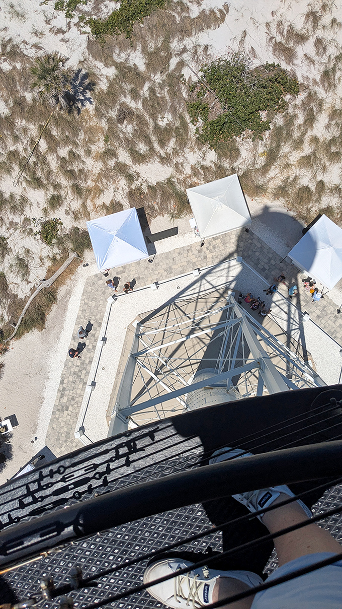 The view from above reveals the lighthouse's perfect hexagonal base, a geometric gem set in Florida's sandy crown.