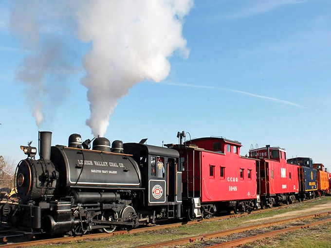 Steam and nostalgia billow from this vintage locomotive, a mechanical dinosaur that once ruled America's transportation kingdom.