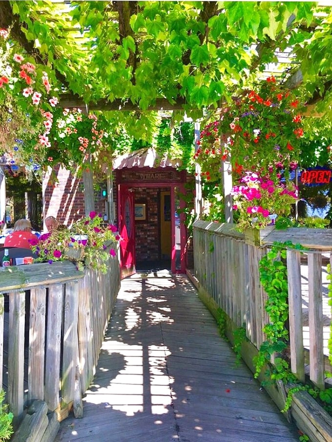 Walking through this vine-covered entrance feels like discovering a secret garden that happens to serve incredible seafood. The flowers are just the opening act.