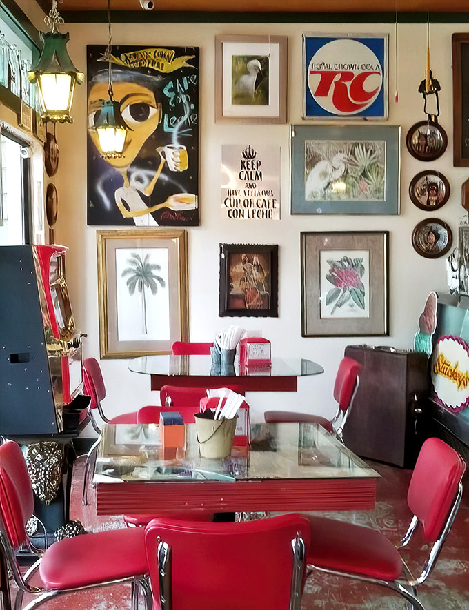 A wall that's part art gallery, part time machine, with vintage signs and Florida imagery creating the perfect backdrop for those red vinyl chairs.
