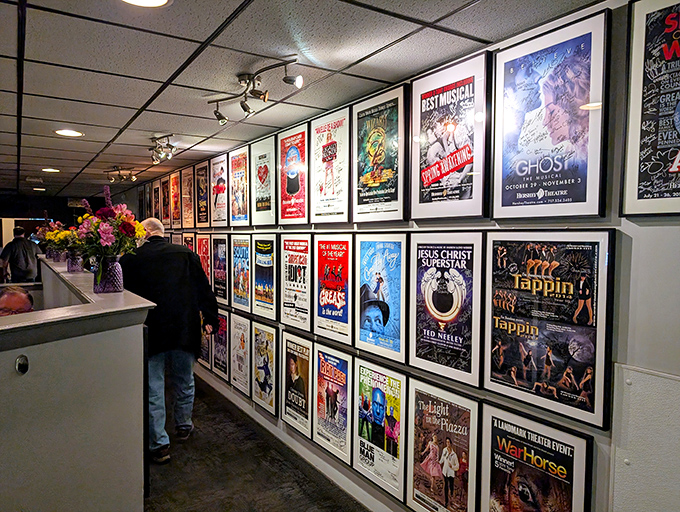 The wall of theatrical posters reminds you that every great meal is a performance worth remembering.