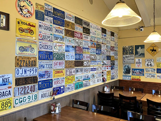 A wall of license plates tells stories of travels far and wide, but the best journey ends right here at this table with fork in hand.