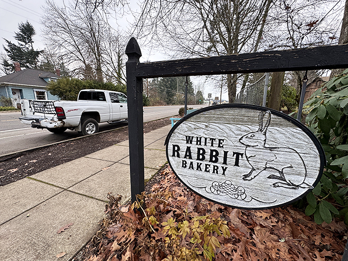 The White Rabbit Bakery's charming sign beckons visitors down the rabbit hole of handcrafted pastries and bread that would make Alice herself linger.