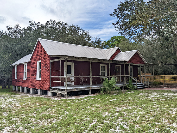 The Whitman House stands as a crimson reminder that before air conditioning, Floridians knew how to catch a breeze with wraparound porches.