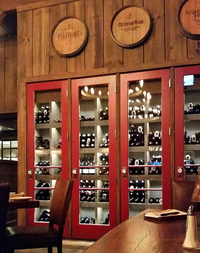 Wine storage that doubles as wall art, with red-framed doors revealing bottles waiting patiently for their moment to shine.