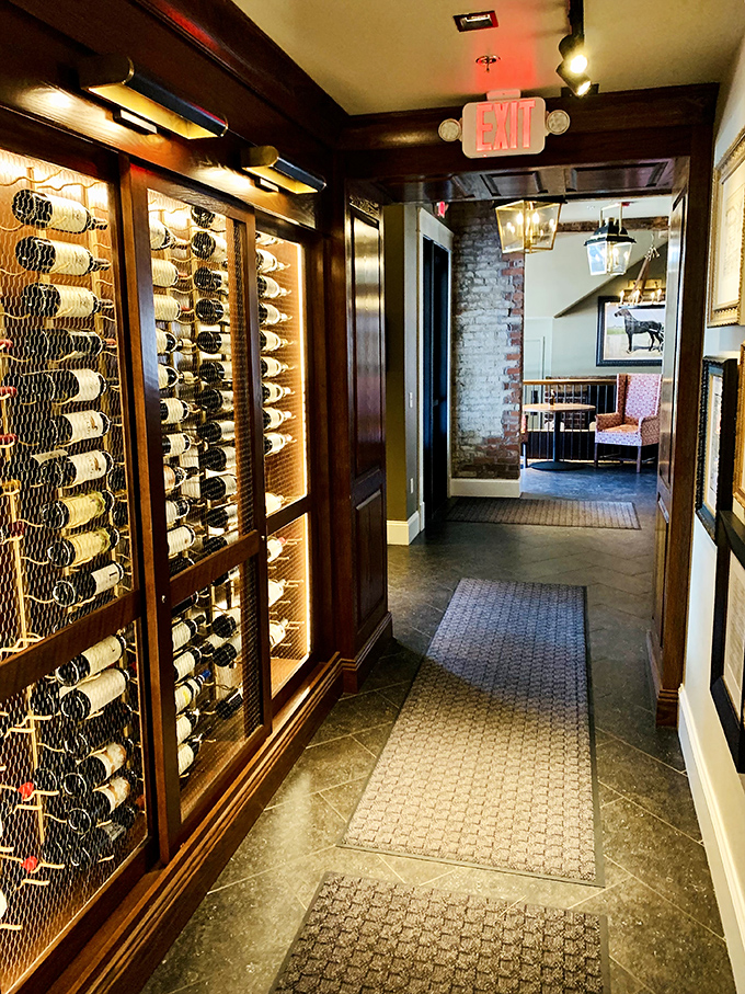 The wine corridor showcases an impressive collection behind glass&mdash;liquid treasures waiting to complement your legendary prime rib.