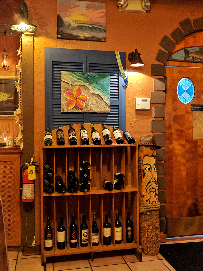 The wine rack stands ready to provide the perfect pairing for your seafood feast, while coastal artwork keeps the maritime theme flowing.